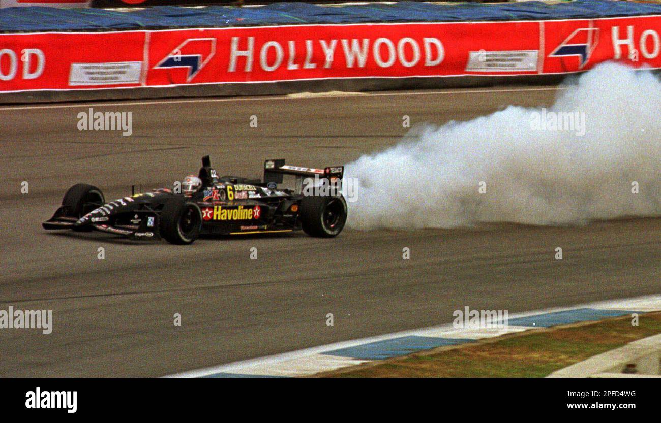 Smoke billows from the car of Michael Andretti during the 49th lap of ...