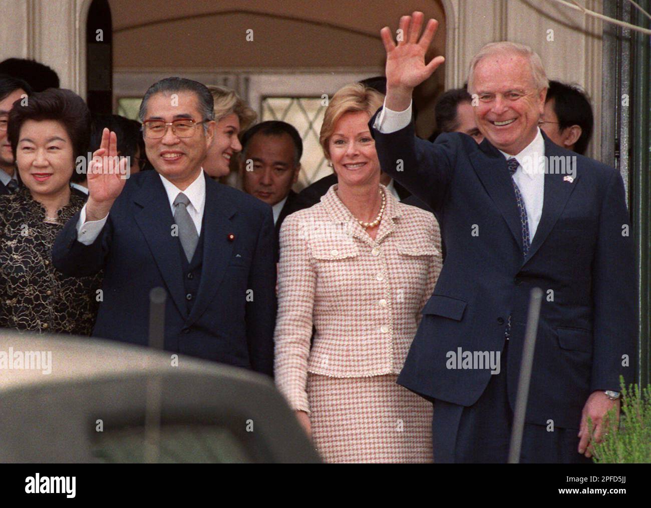Japanese Prime Minister Keizo Obuchi, second from left, waves with his ...
