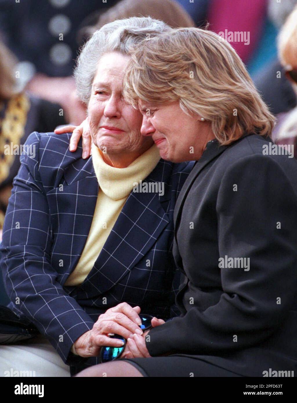 Mary June Martin, left, and Karen Martin weep at the funeral for Air ...