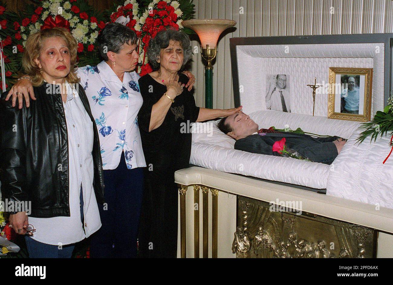 Armando Perez's mother, third from left, and sisters mourn his death at ...
