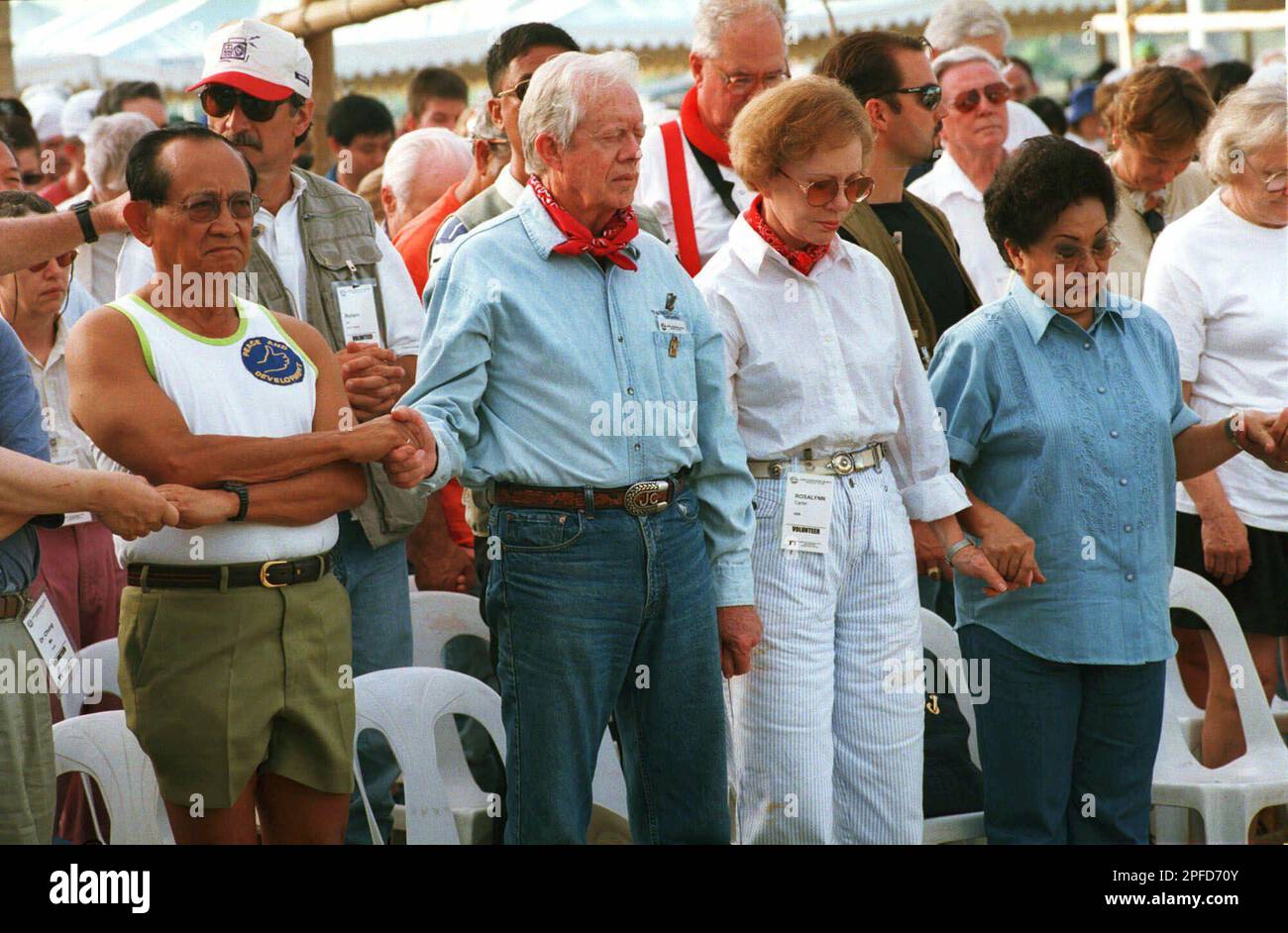 Former U.S. President Jimmy Carter, second from left, joins hands with ...