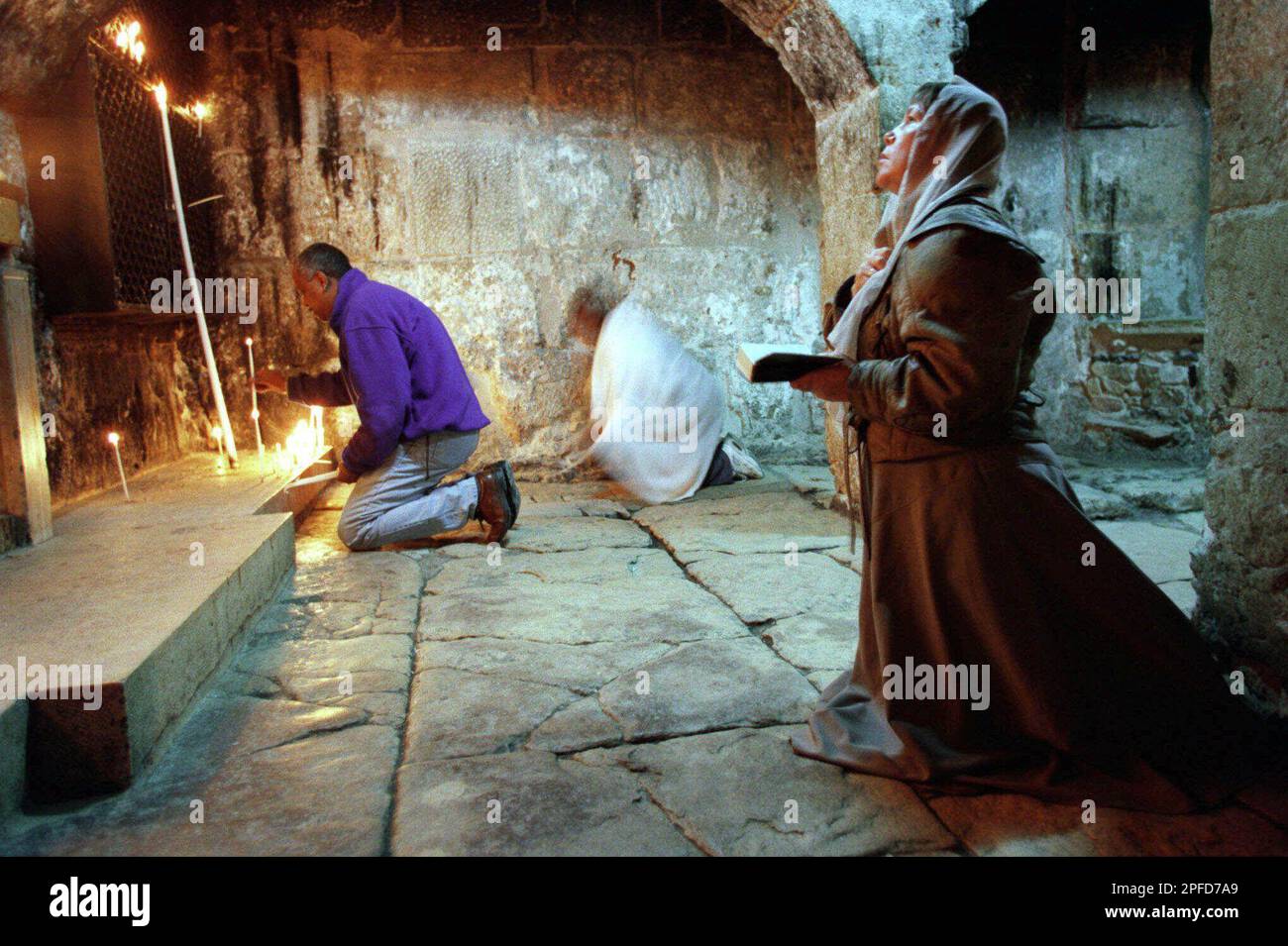 Pilgrims worship and light candles in a chapel where it is believed ...