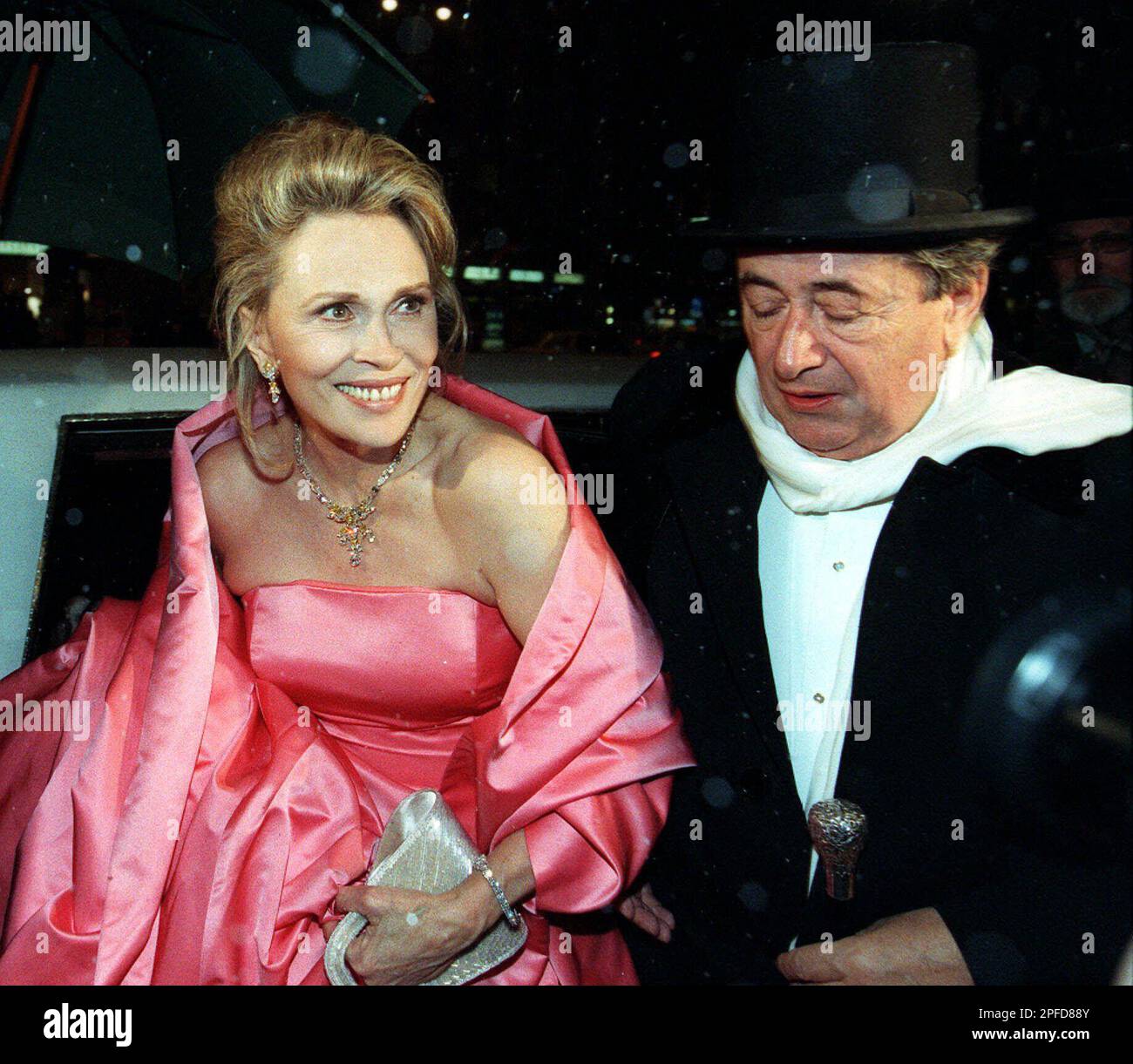 Actress Faye Dunaway, left, is helped by her host, Austrian businessman ...