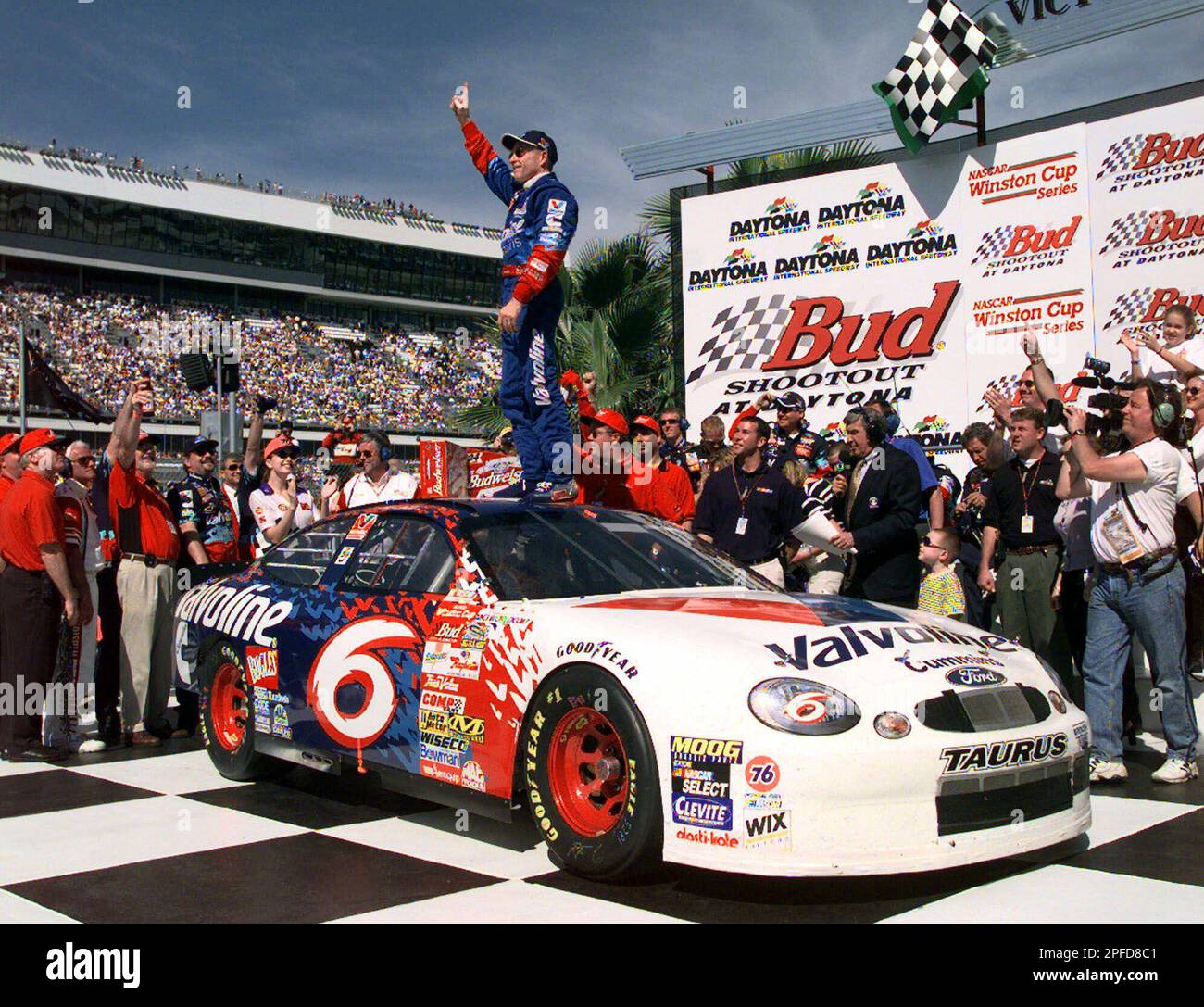 Mark Martin, from Batesville, Ark., stands on top of his Ford after ...