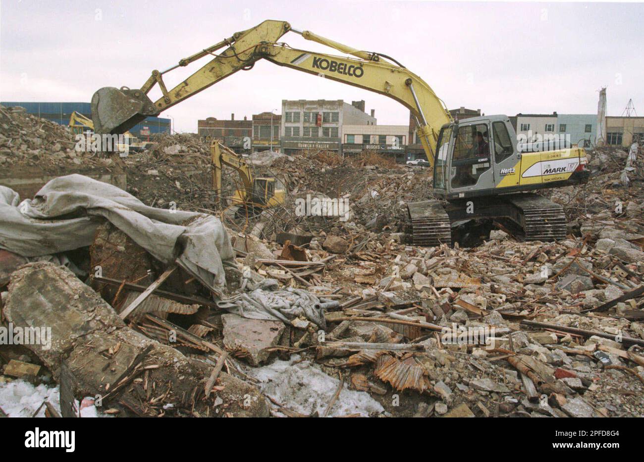 City workers in Gary, Indiana, use heavy equipment to remove the rubble ...