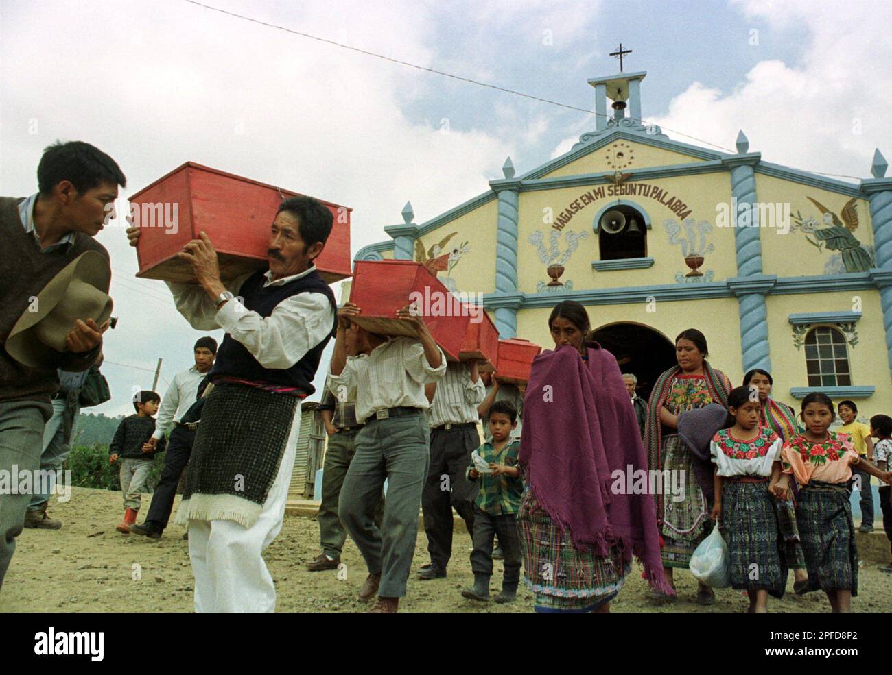 Mayan men carry the caskets of 20 victims of Guatemala's civil war from ...