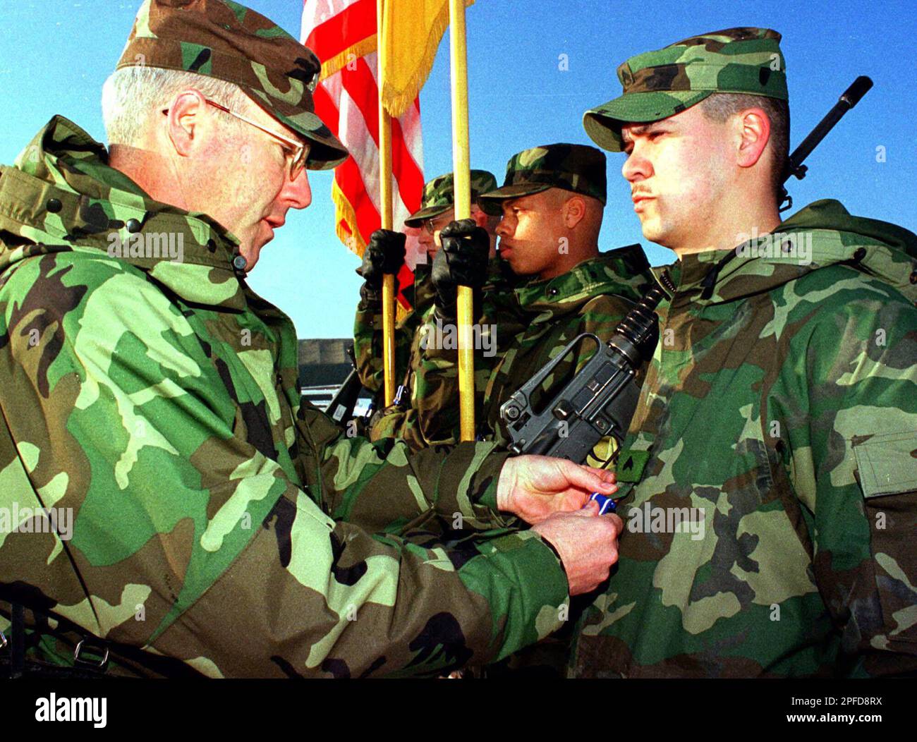U.S. Army Lt. Col. Barry Fowler of Overland Park, Kan., left, awards ...