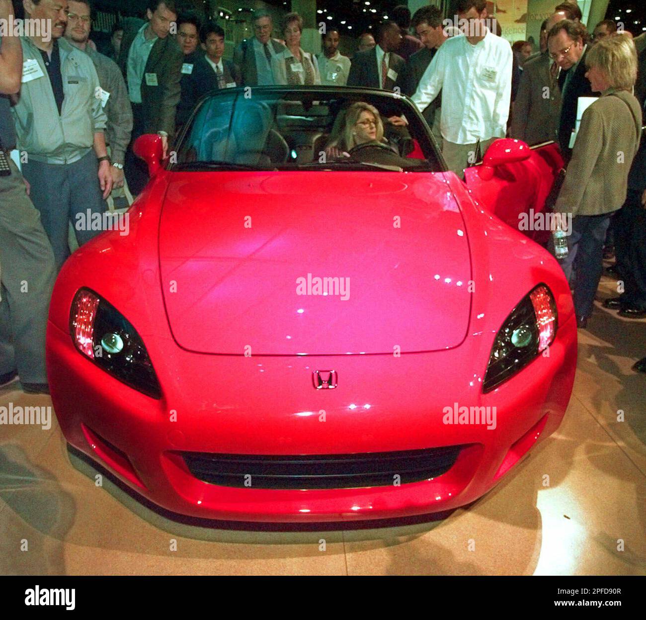 Members of the automotive media crowd around the high-tech Honda S2000 ...