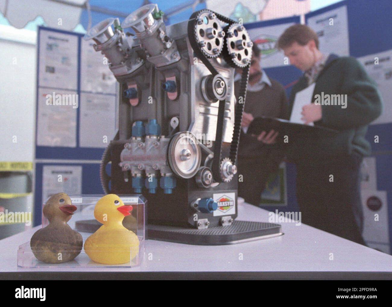 Two rubber ducks sit near a four-stroke watercraft engine outside the ...