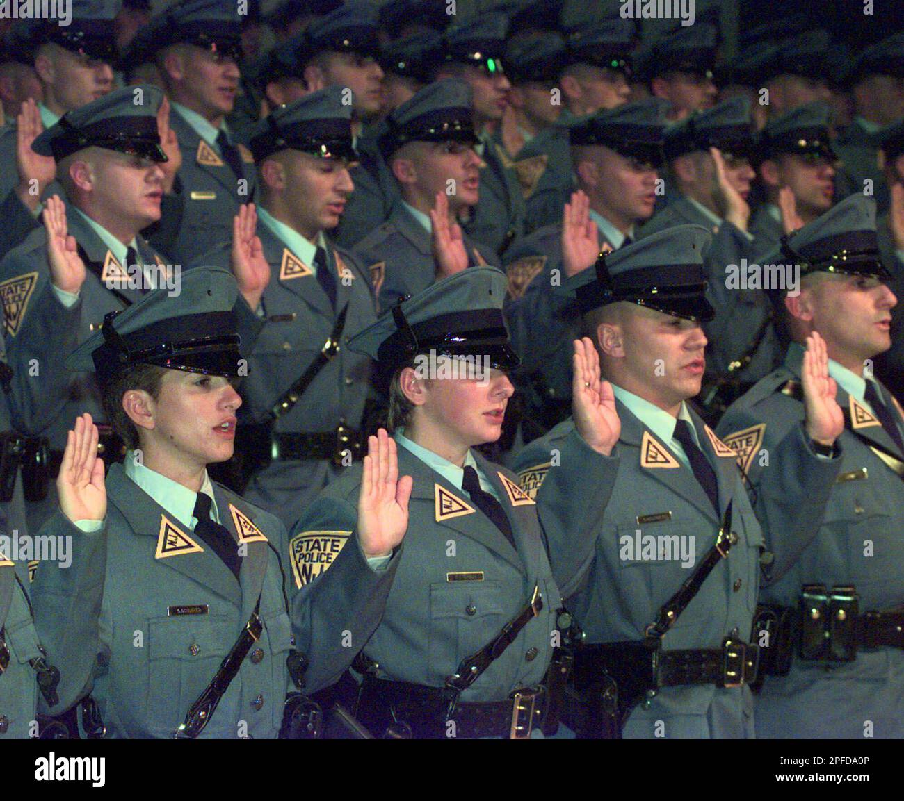 Recruits from the 118th New Jersey State Police Training Class take the oath during graduation ...