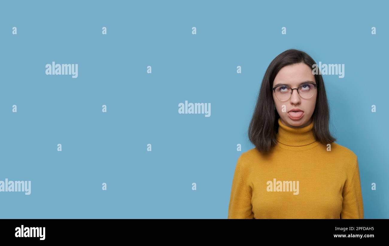 Portrait of an emotional student girl with glasses depicting facial ...