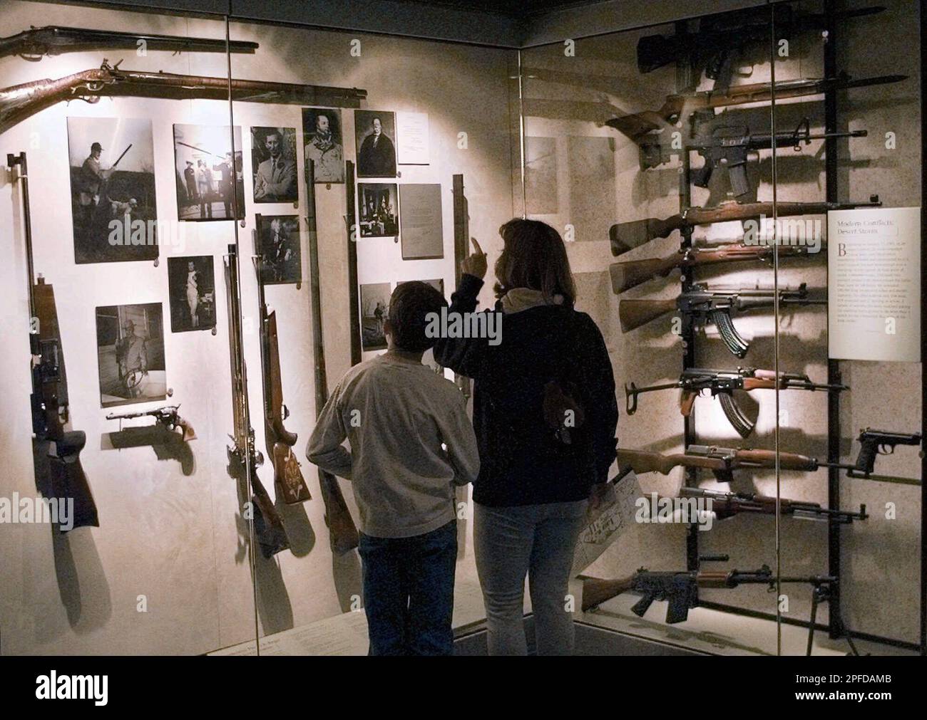Visitors to the National Rifle Association Museum look at one of the ...