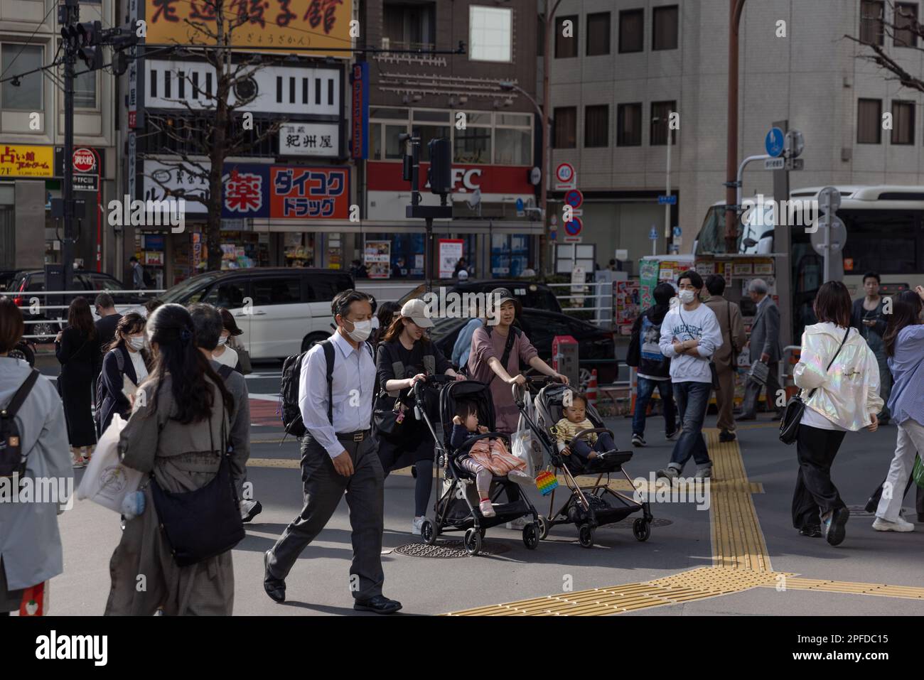 Women push their strollers with their kids near Shinjuku station in ...