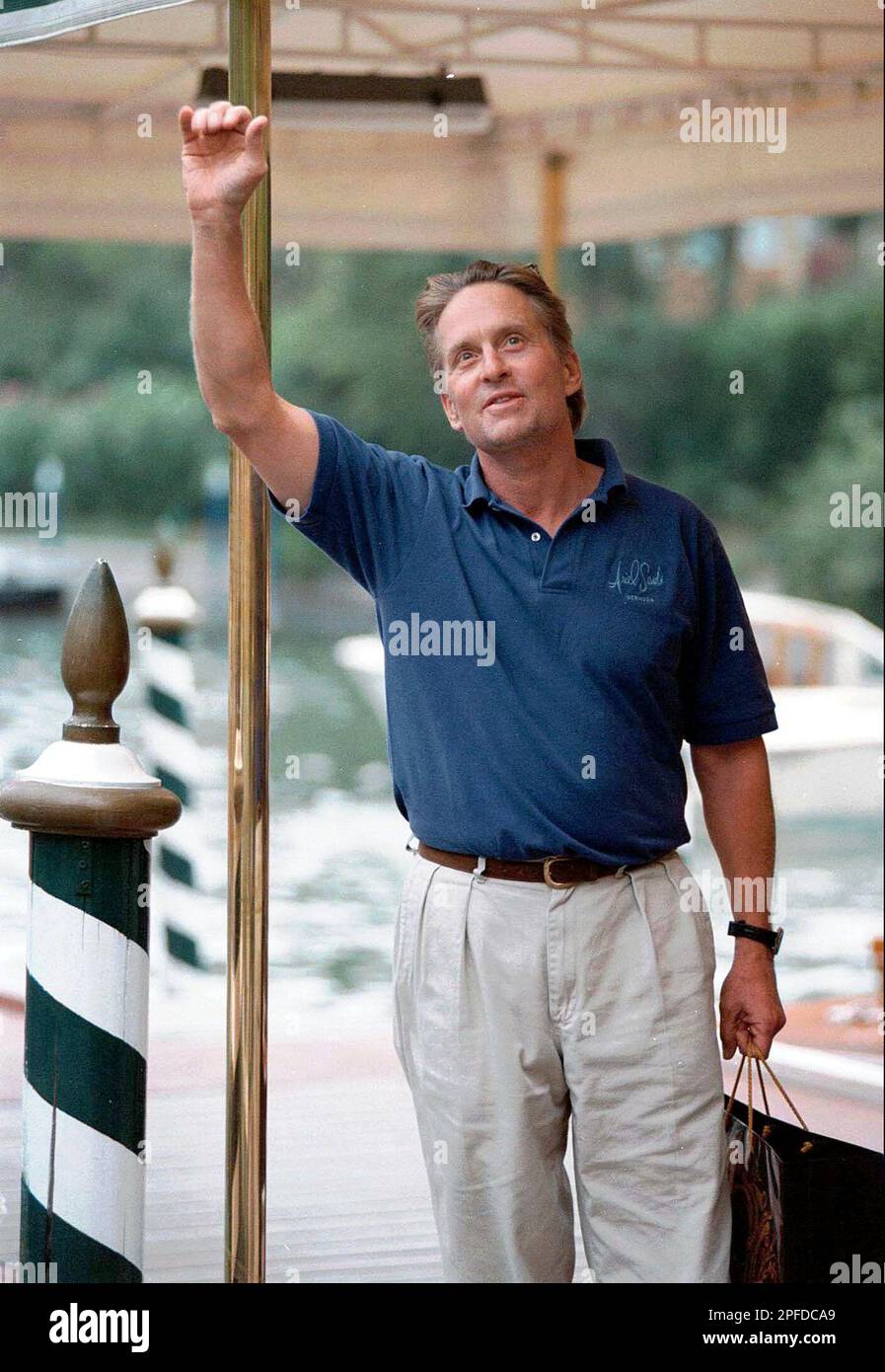 American actor Michael Douglas waves as he arrives in Venice Friday ...