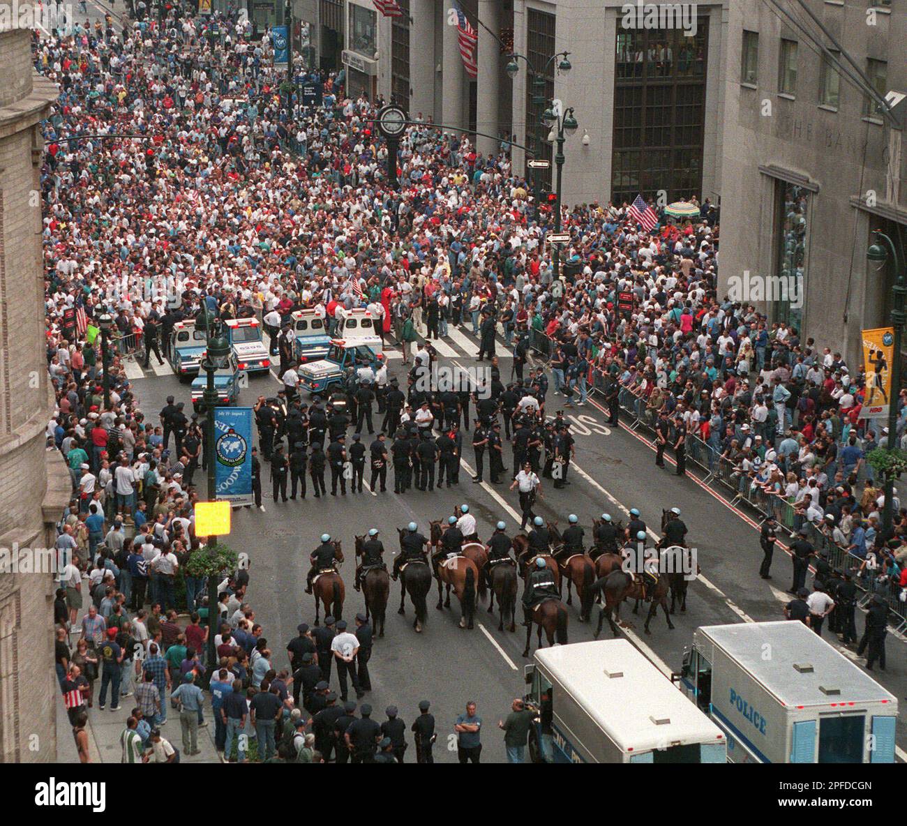 New York City police, including mounted officers, face a crowd of union ...
