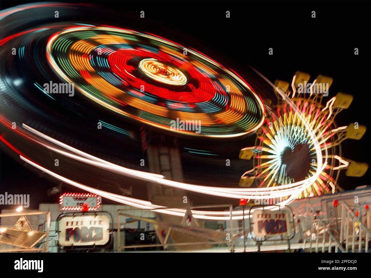 Colorful lights from Force 10 and the Astro Wheel carnival rides light ...