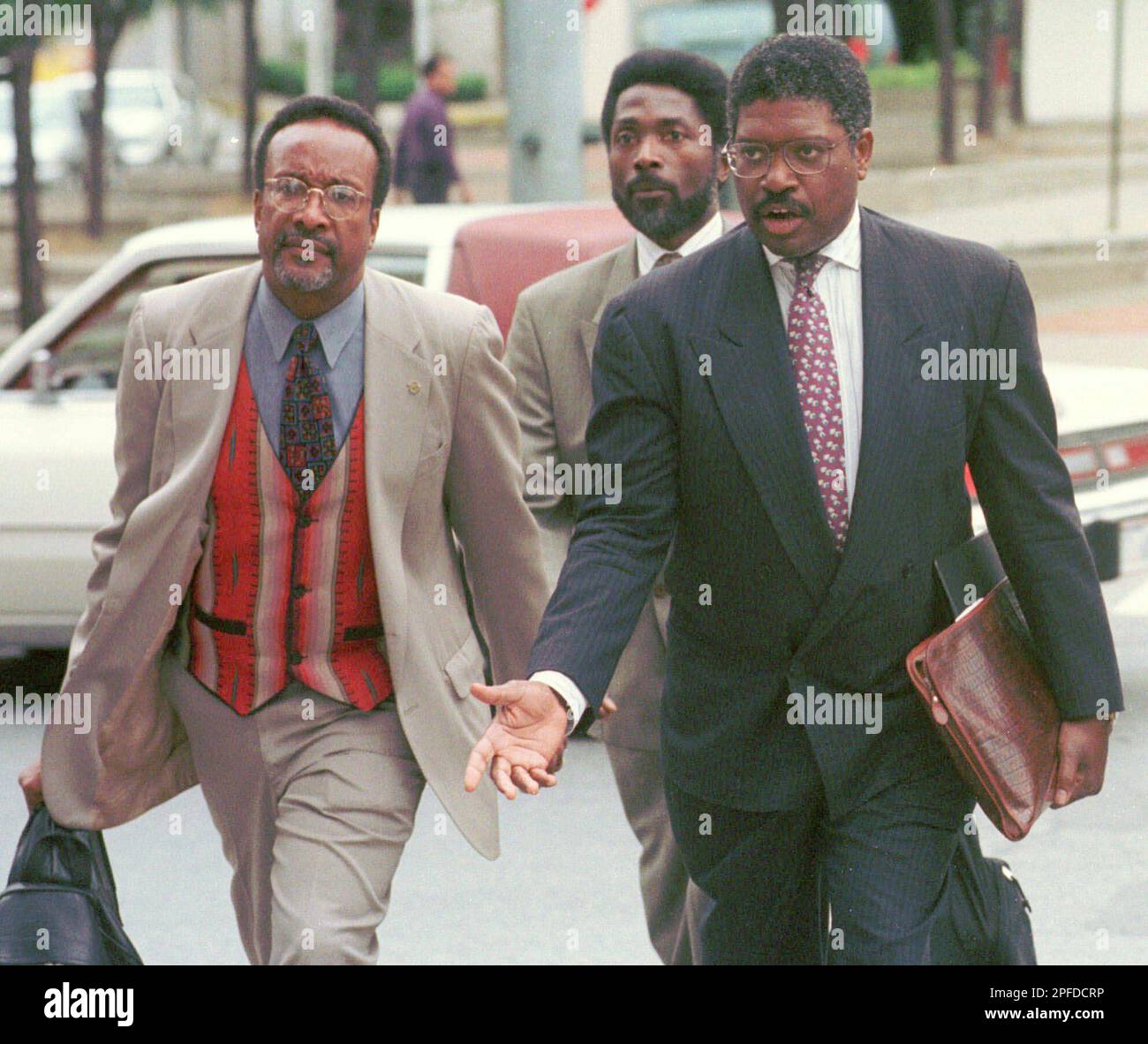 C. Vernon Mason, left, and Alton Maddox, Jr., right, walk to the ...