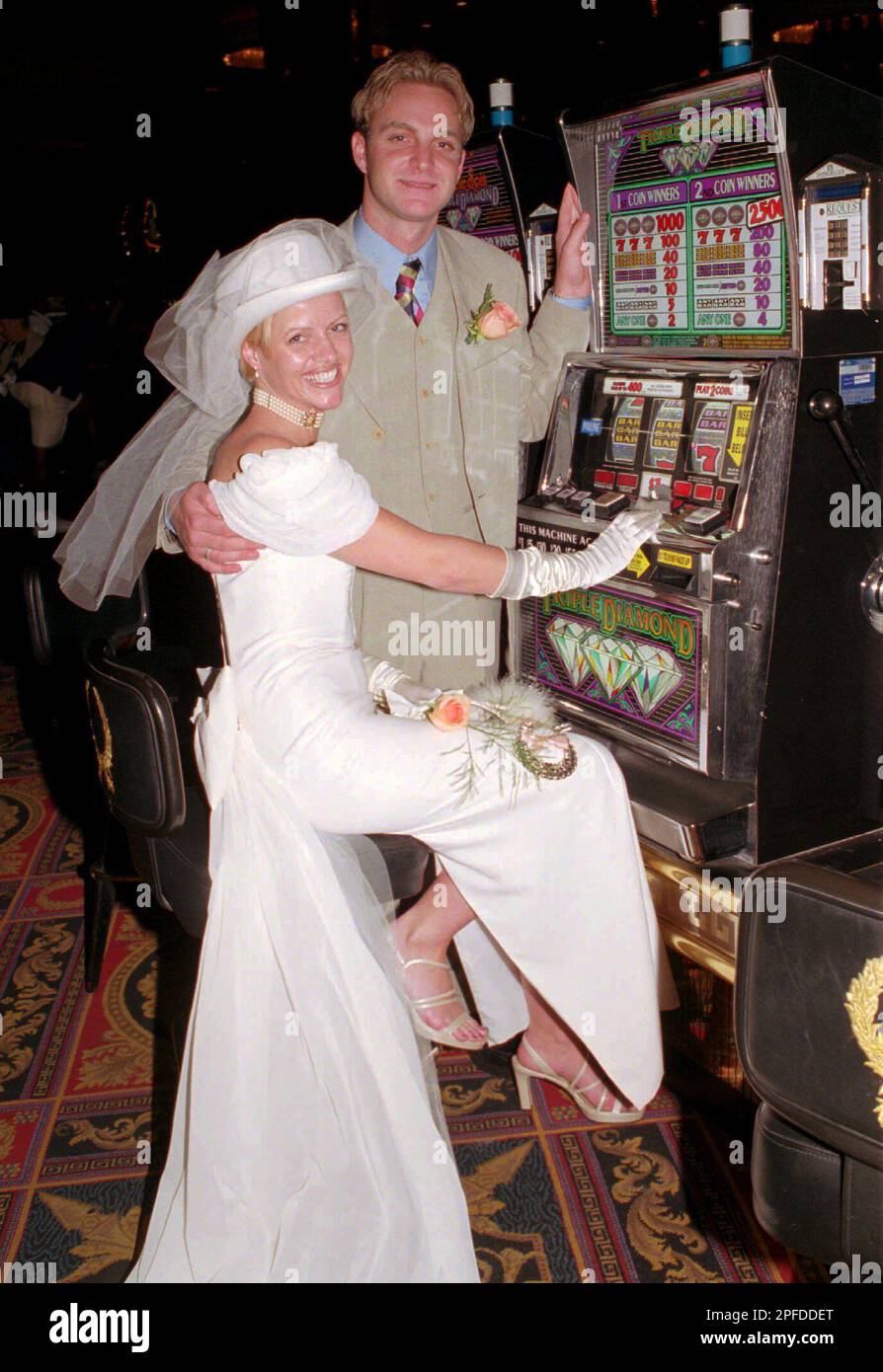 Newlywed Sian Truelove, left, plays the slot machine at Caesars Palace ...