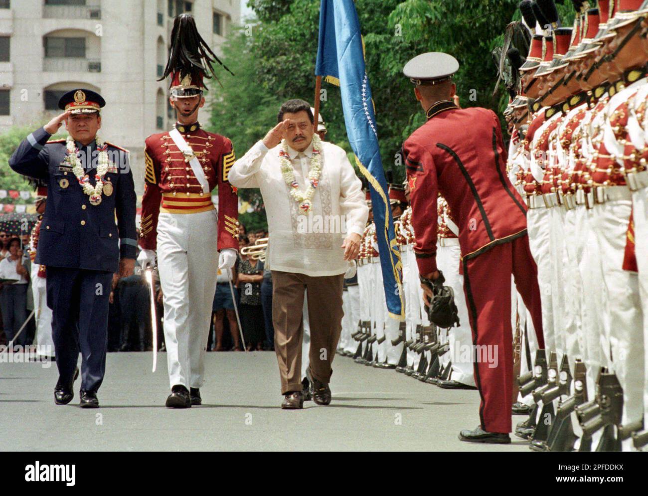 A uniformed cadet of the Philippine National Police emerges from the ...