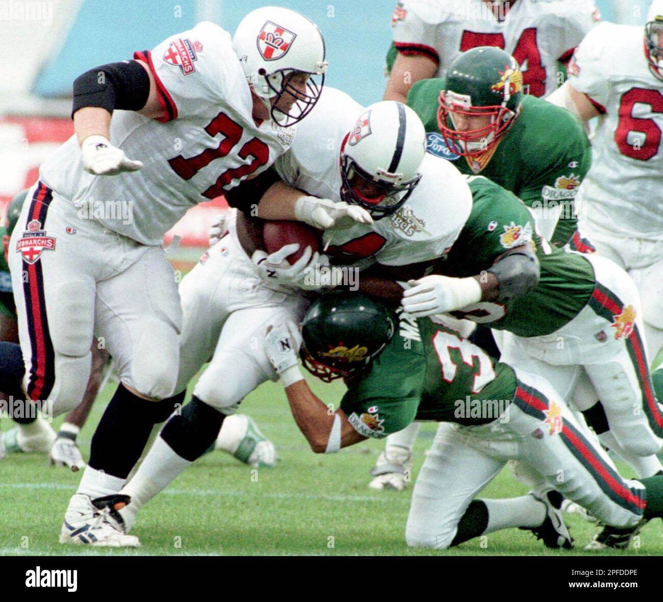 England Monarchs' player Robert Couch, left, tries to protect teammate ...