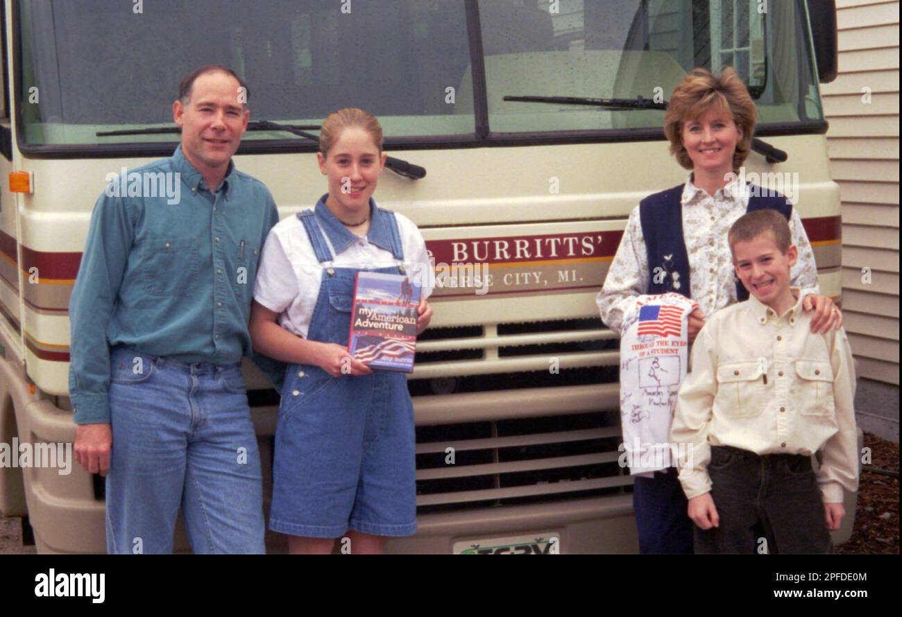 Fifteen-year-old Amy Burritt, second from left, holds a copy of her ...