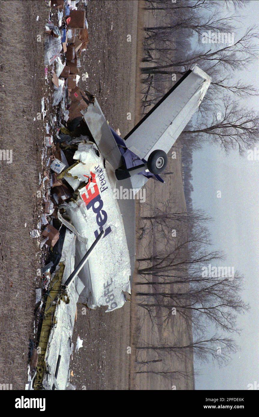 The remains of a small Federal Express cargo plane that crashed in a ...