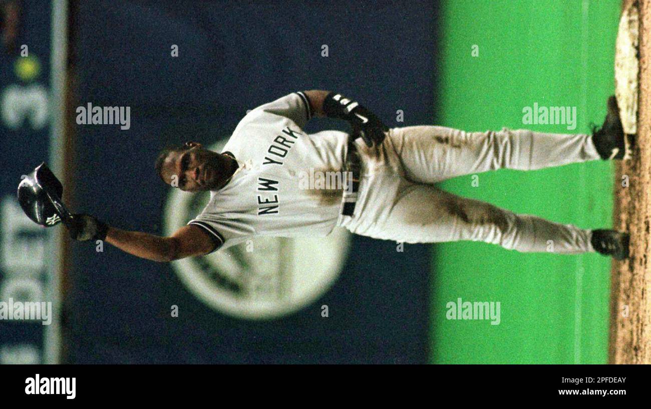 New York Yankees' Tim Raines raises his batting helmet to a standing ...