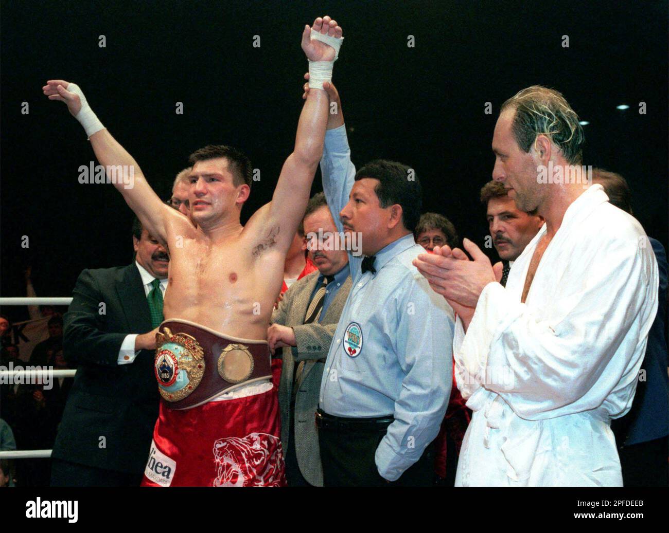 Referee Raul Caiz, center, declares Dariusz Michalczewski of Germany ...