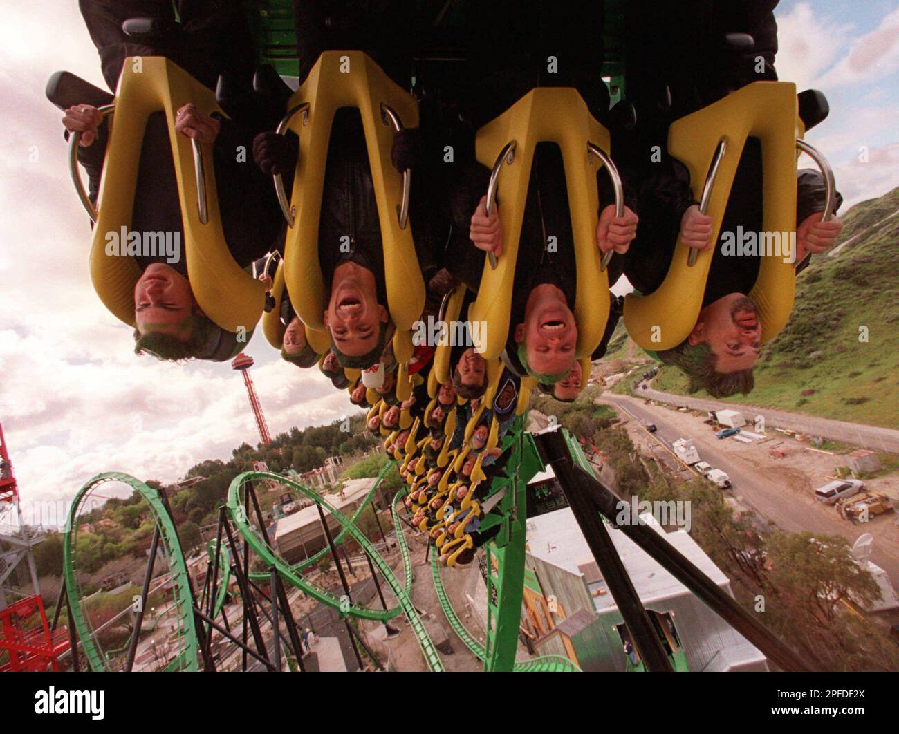 Roller coaster enthusiasts, some sporting green hair like Batman's ...