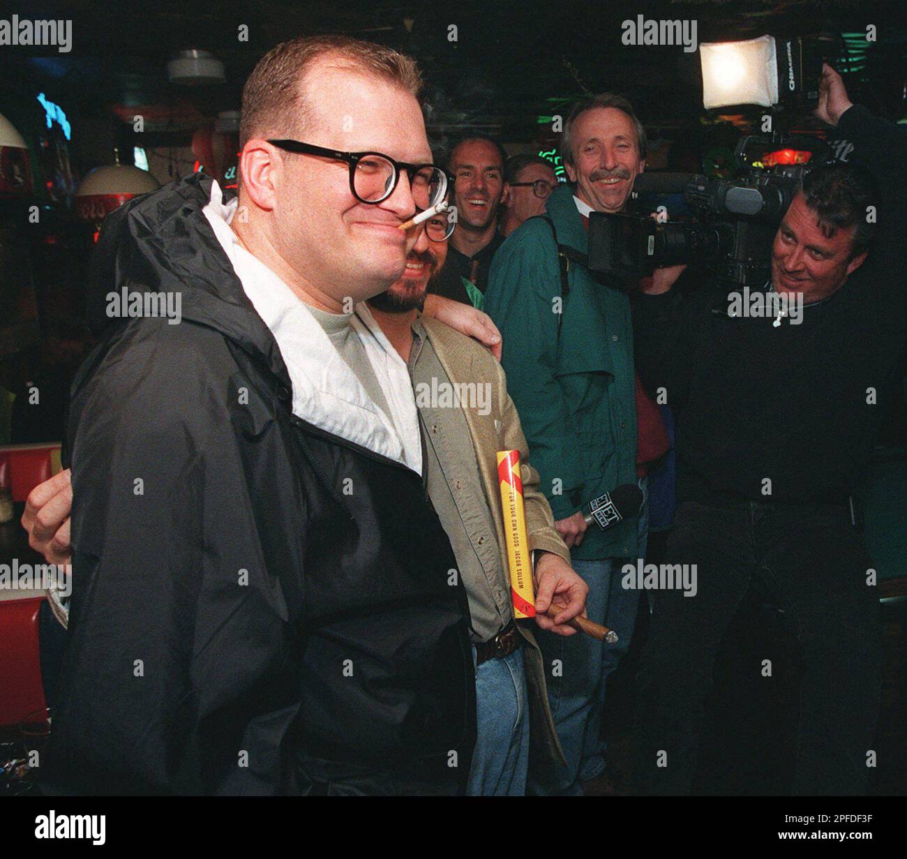 Comedic actor Drew Carey smokes a cigarette in front of patrons and ...