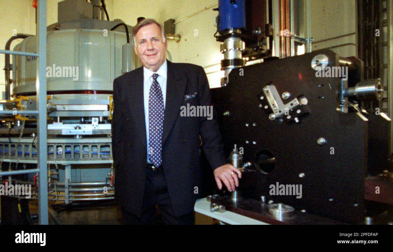 John Masefield, chairman of Isomedix, stands next to an electron ...