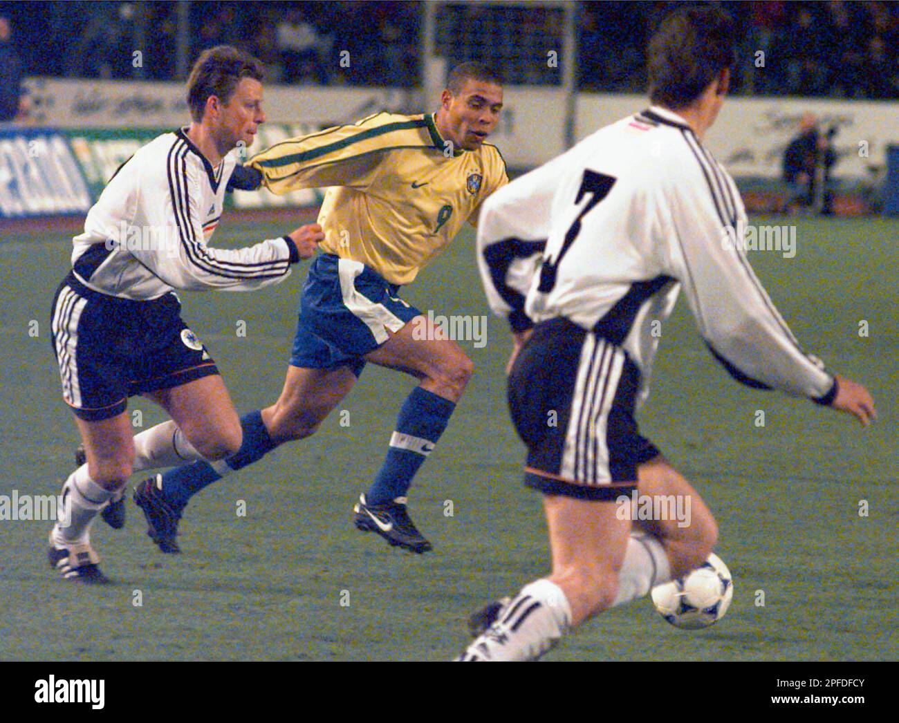 Brazil's Ronaldo, center, is attacked by Germany's Christian Woerns ...