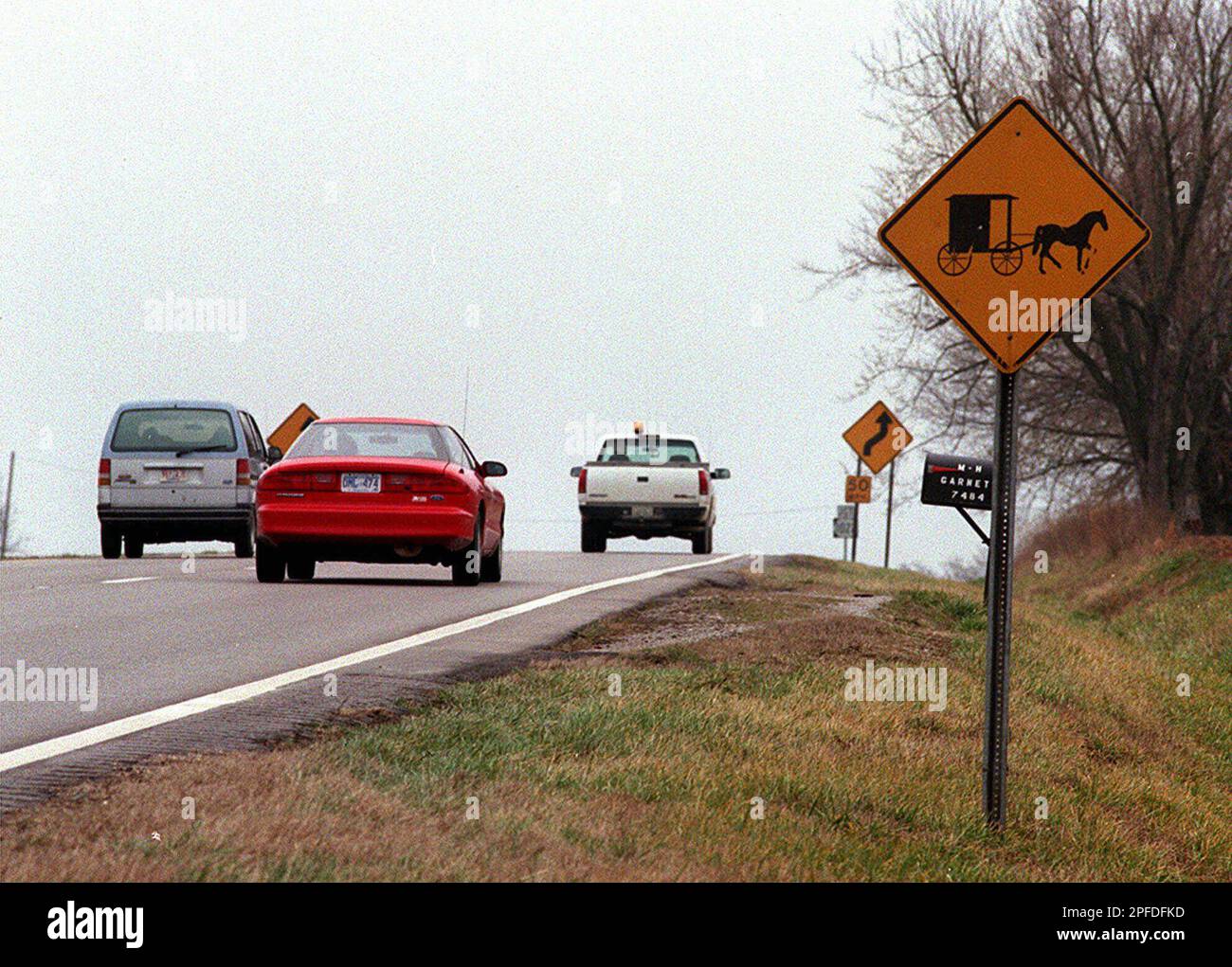 Cars travel past a Amish buggy warning sign on Fort Campbell Boulevard ...