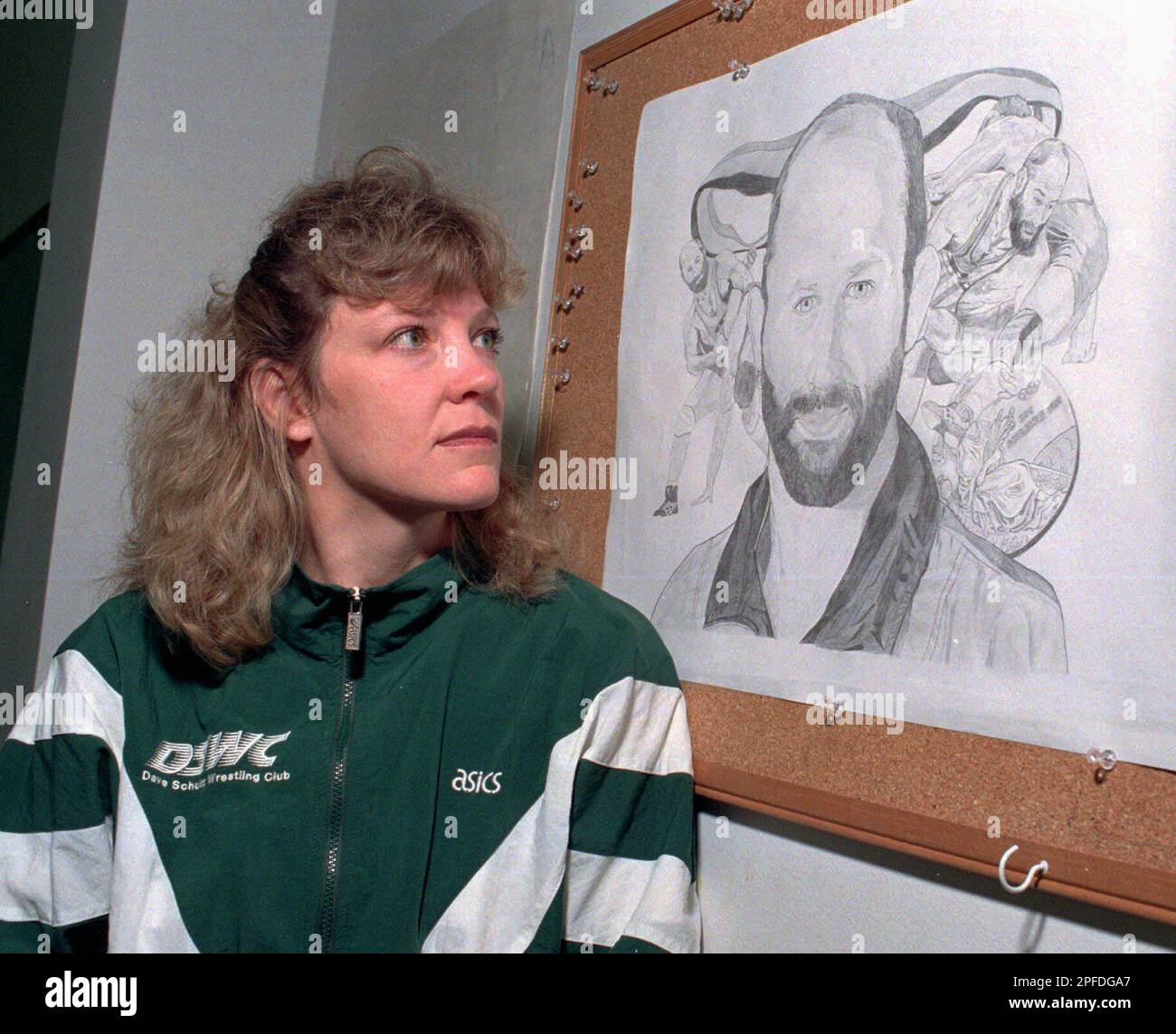 Nancy Schultz looks at drawing of her late husband David Schultz, an ...