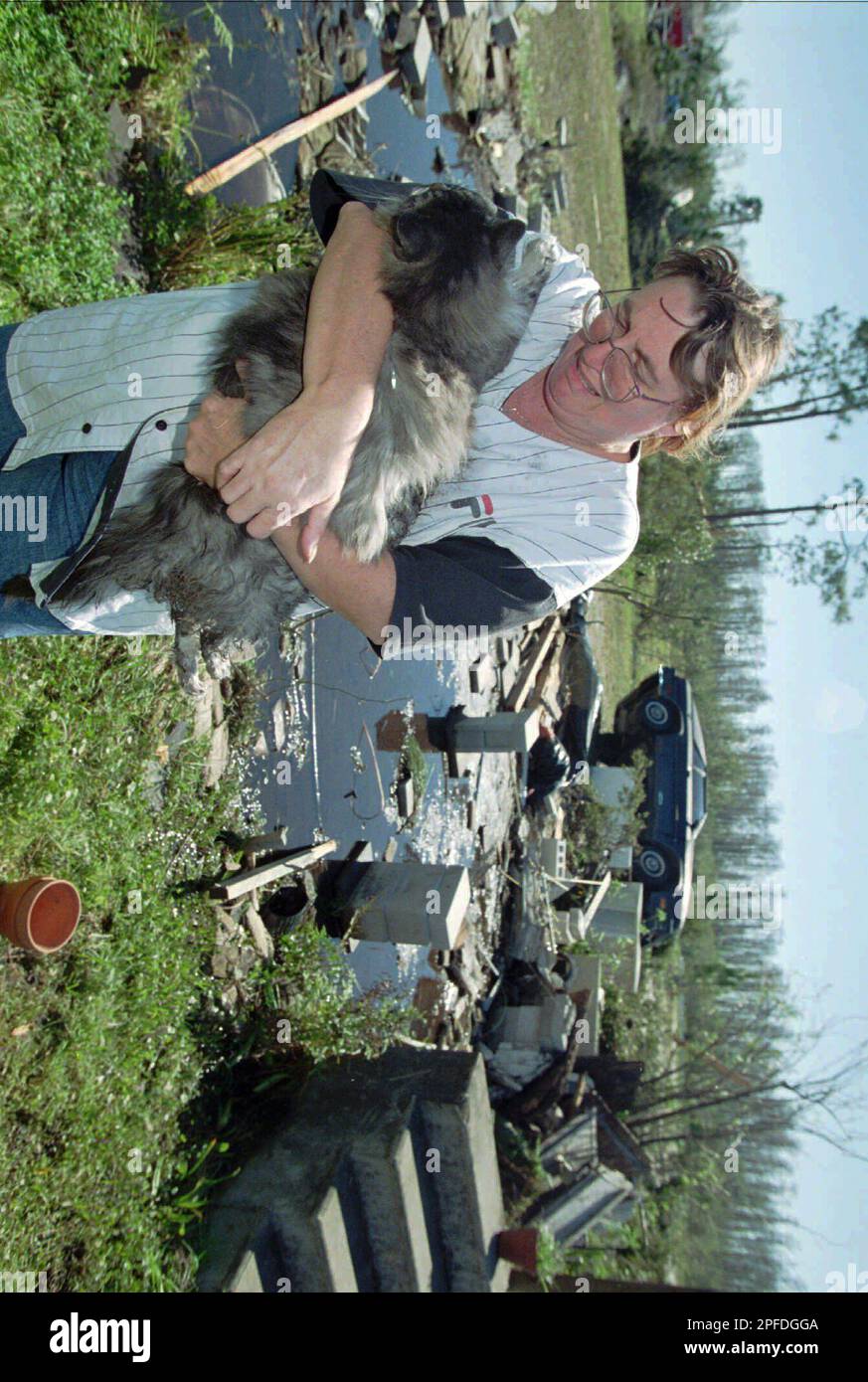 Judith Ramirez cries as she retrieves the family cat from what was once ...