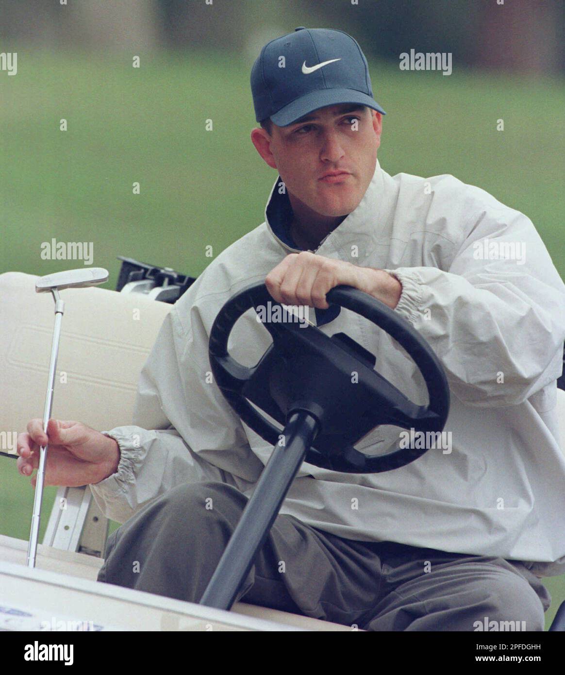 Nike Tour golfer Casey Martin holds a putter as he sits behind the ...