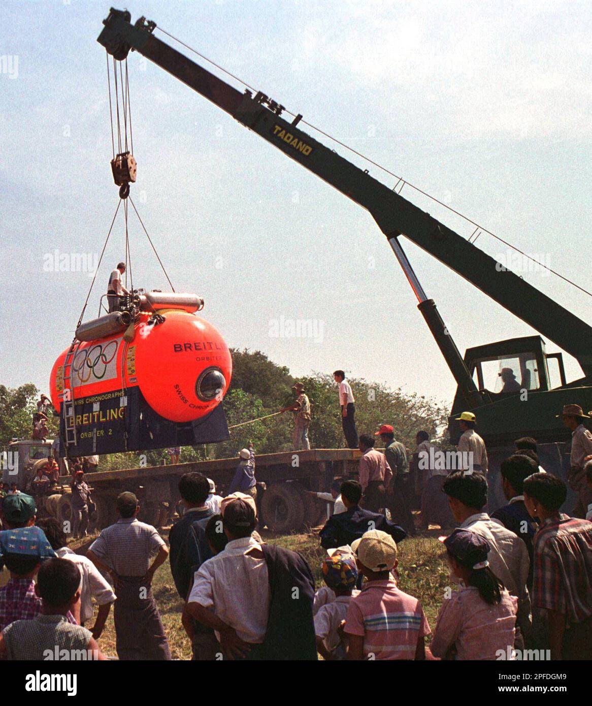 Burmese military officials loads the balloon Breitling Orbiter 2 onto a ...