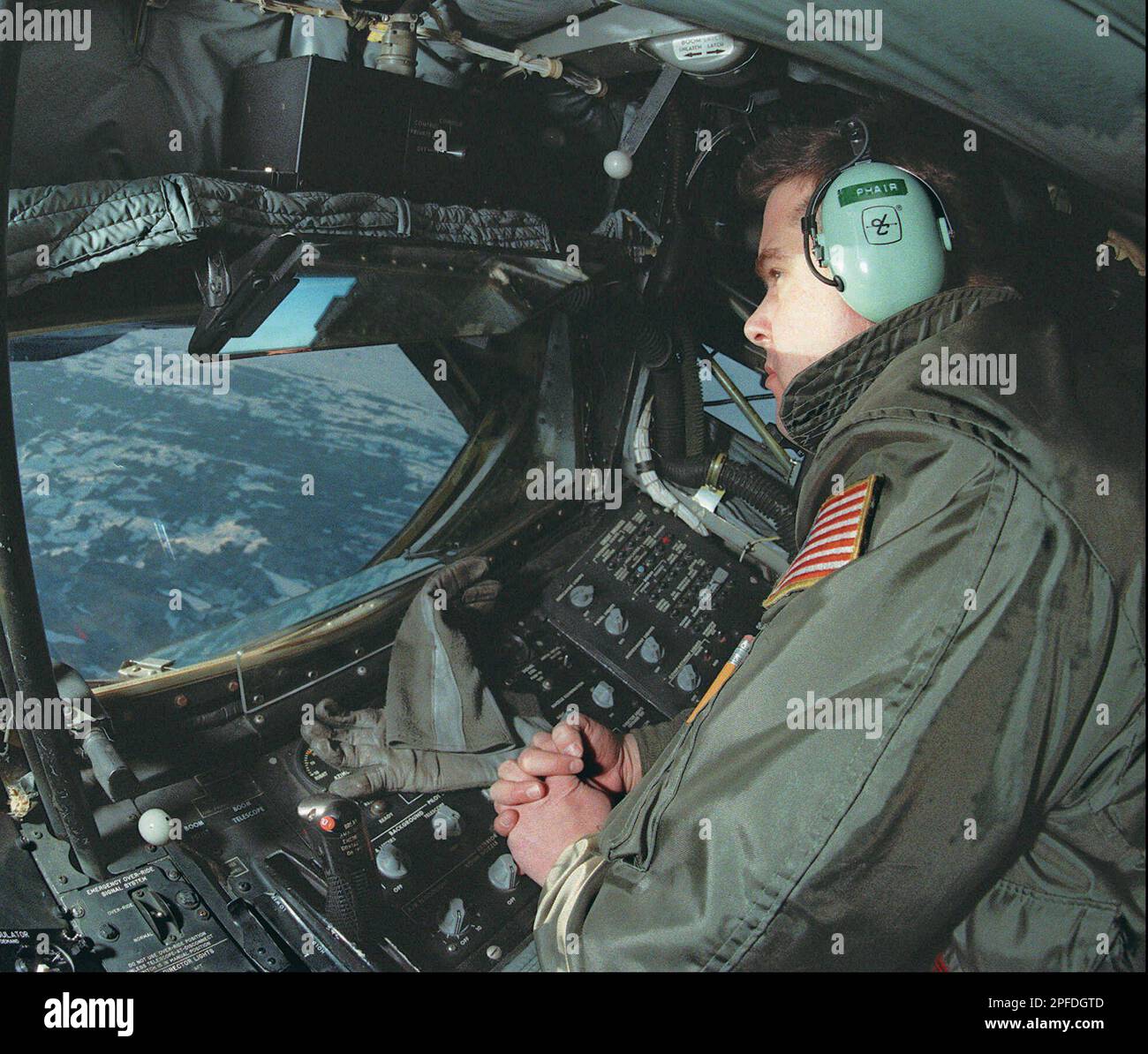 Working in the boom pod in the aft of the fuselage of a KC-135 Stratotanker, in-flight air ...