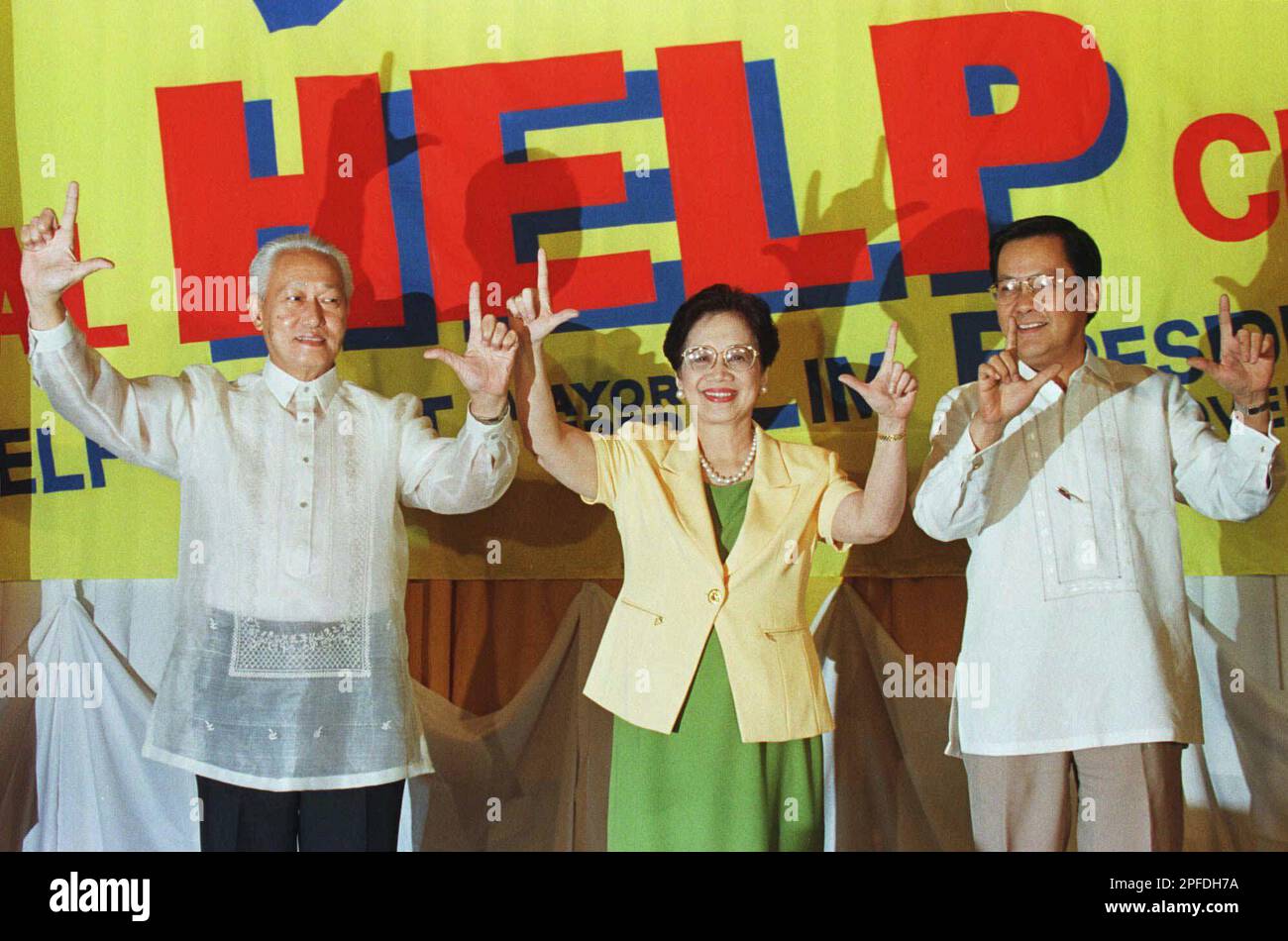 Former Philippines President Corazon Aquino, center, flashes her ...