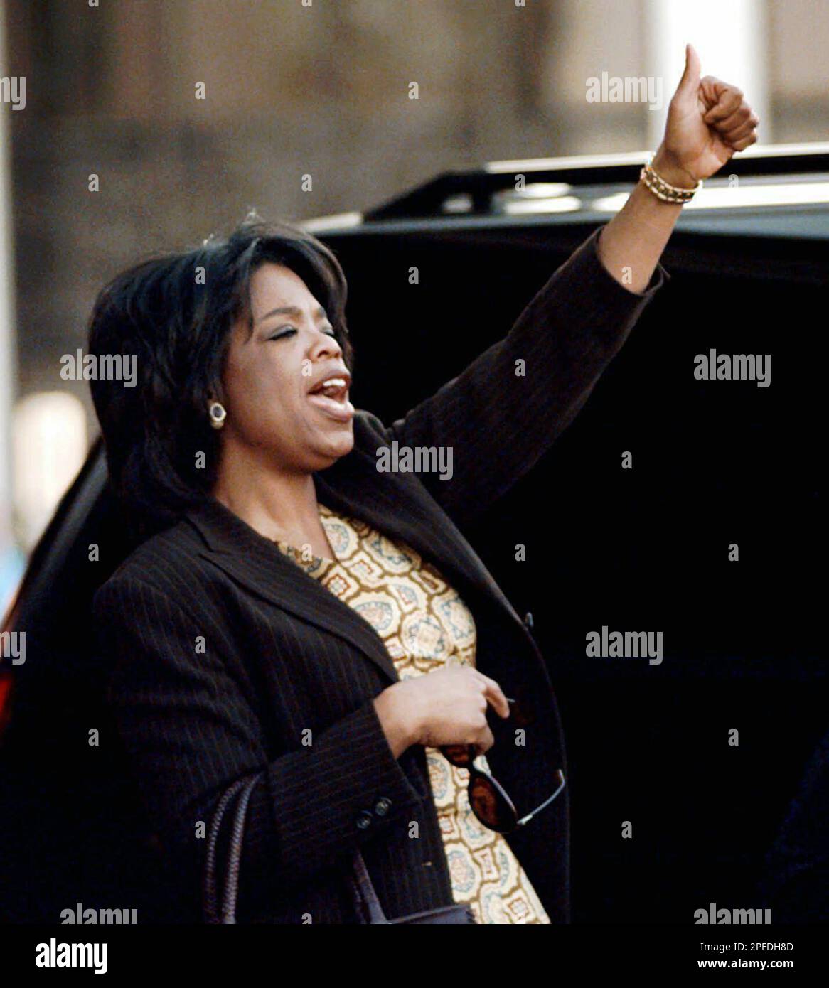 Talk show host Oprah Winfrey acknowledges fans while leaving the ...