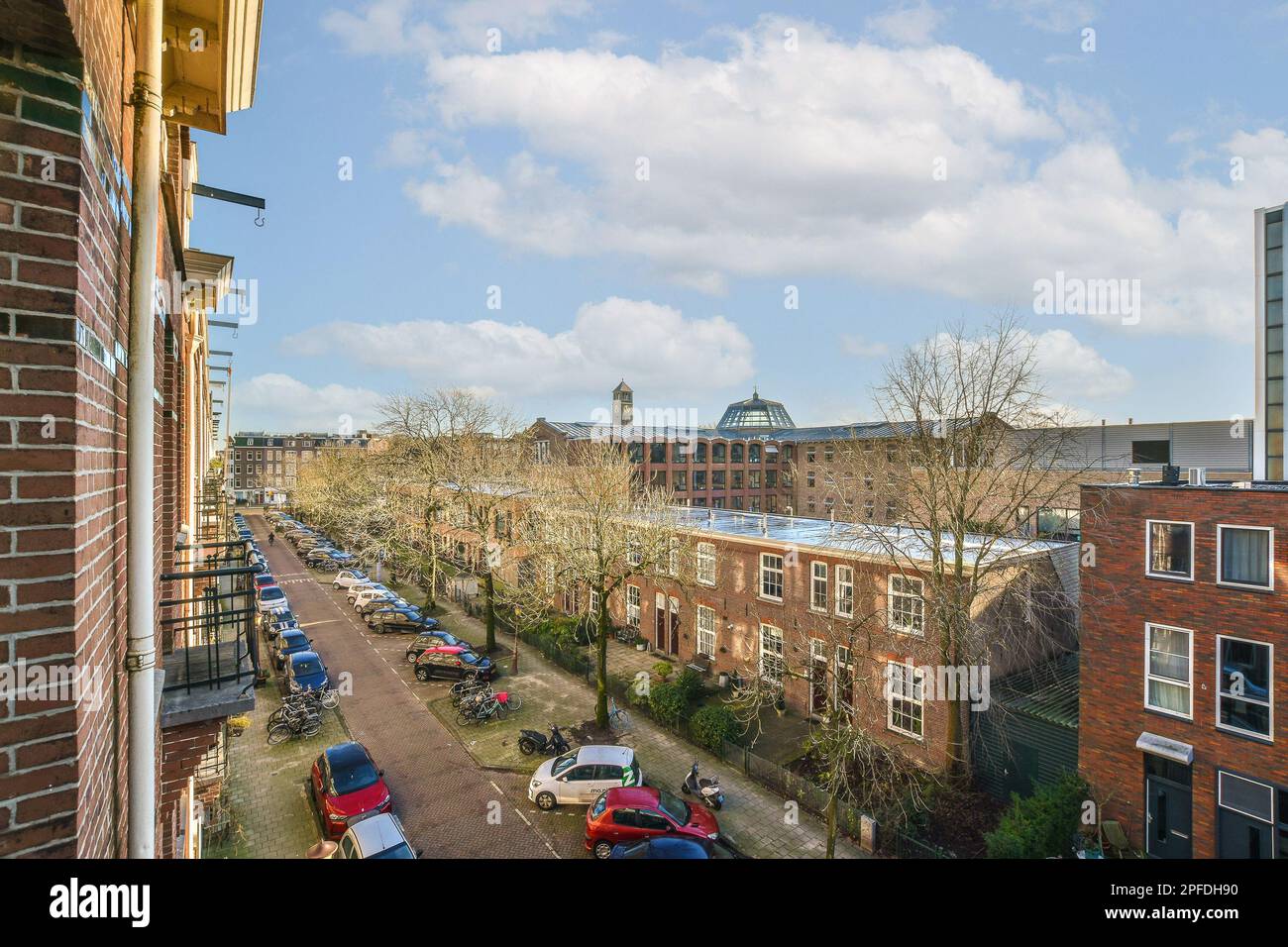 cars parked on the side of a street in an urban neighborhood, taken ...