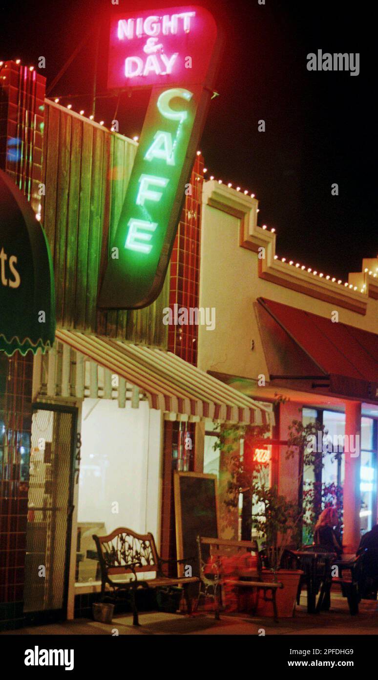 The neon sign of the "Night & Day Cafe" lights up the empty street in ...