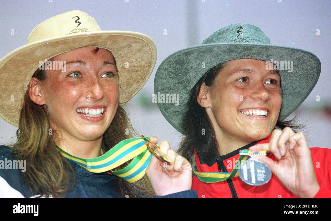 Amy Van Dyken of the USA and Sandra Voelker of Germany show their gold ...