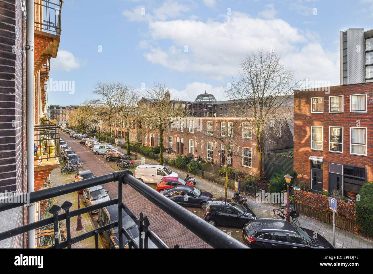 an outside area with cars parked on the street and buildings in the ...
