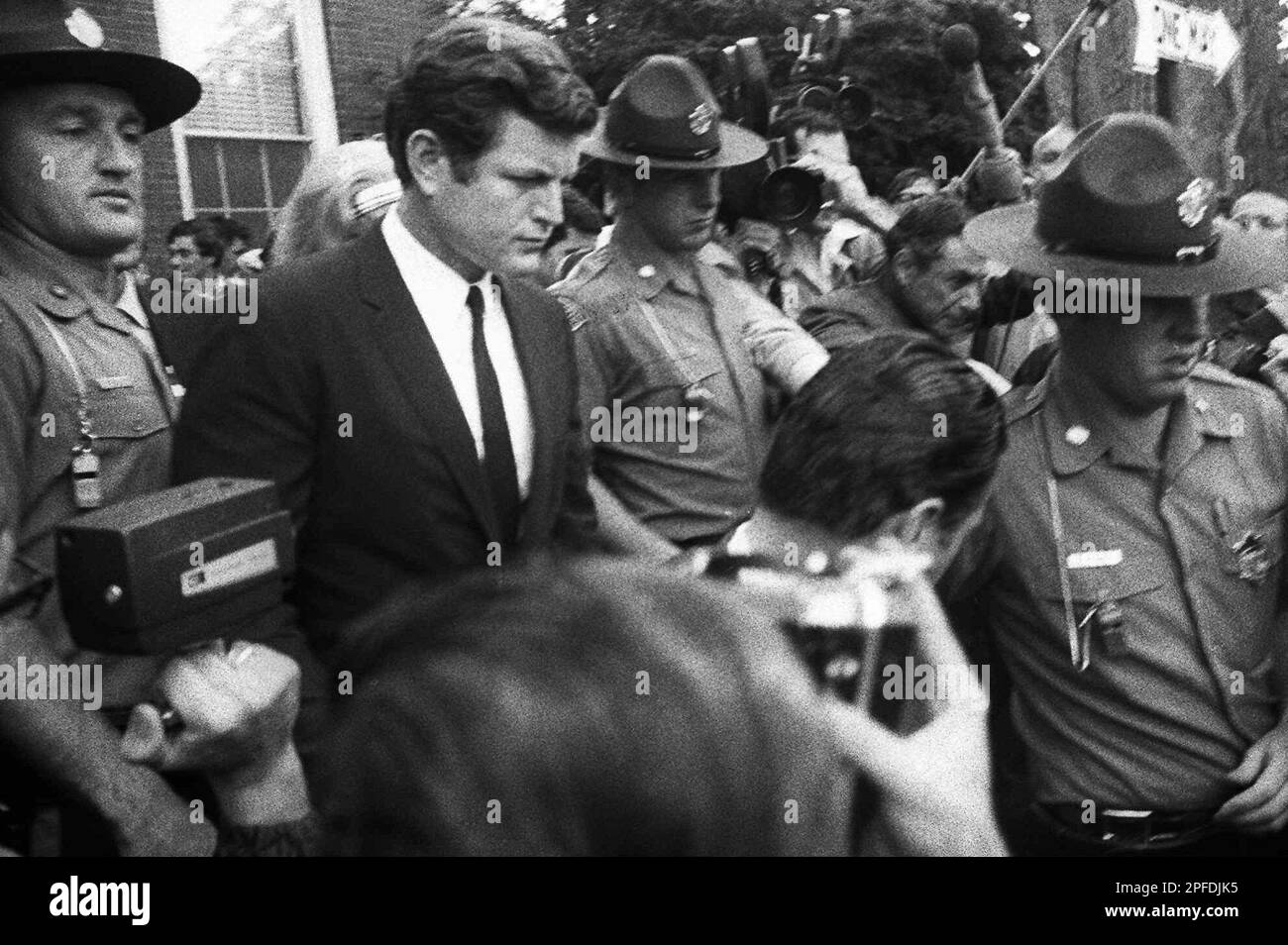 Sen. Edward Kennedy is escorted by troopers as he leaves court in ...
