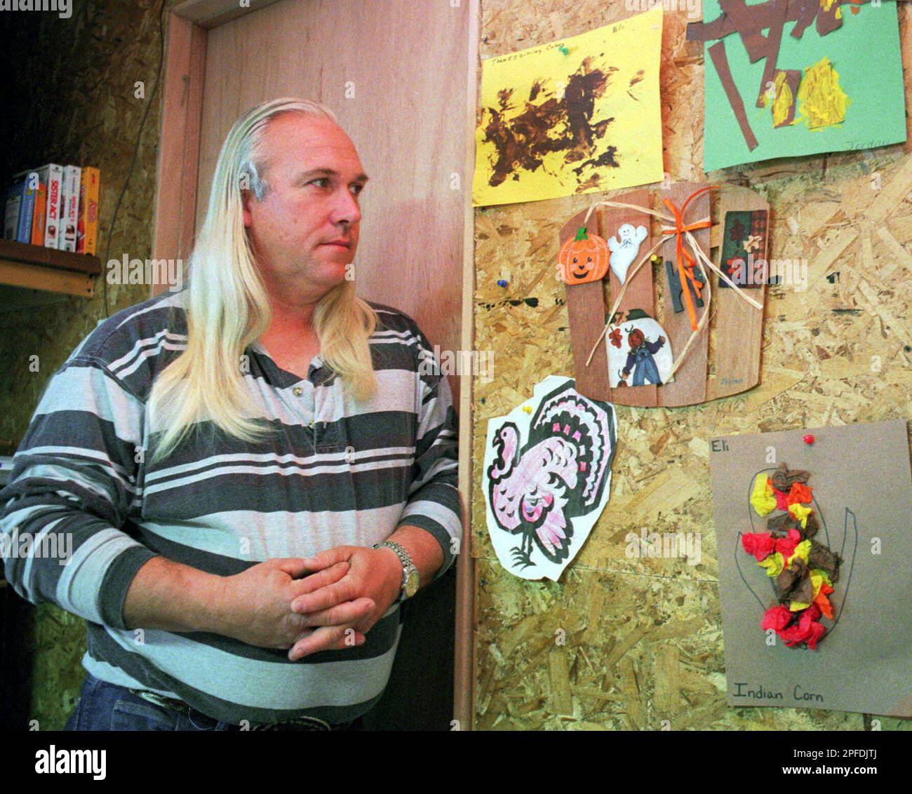 Sam Evans stands next to artwork created by his grandchildren Jordan ...