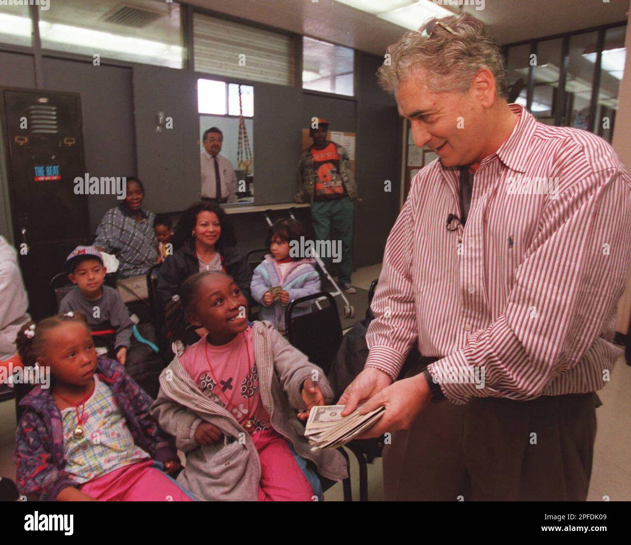 An anonymous benefactor, known only as the "Eldorado Elf," hands out ...