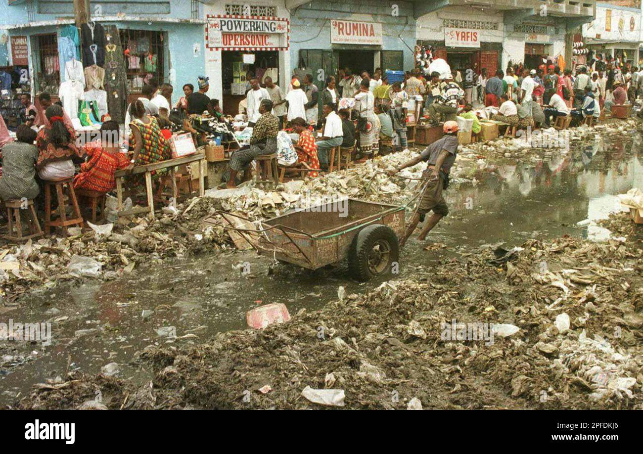 Vendors sell their produce in the city market filled with mud, garbage ...