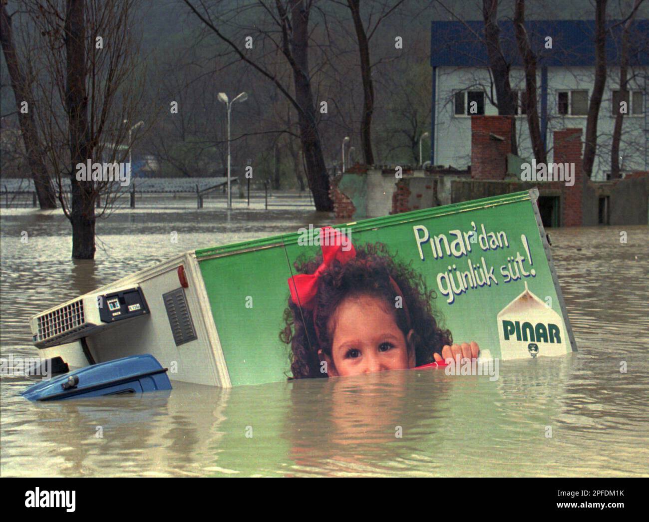 A truck carrying milk sinks deeply in to water in front of the Pinar ...