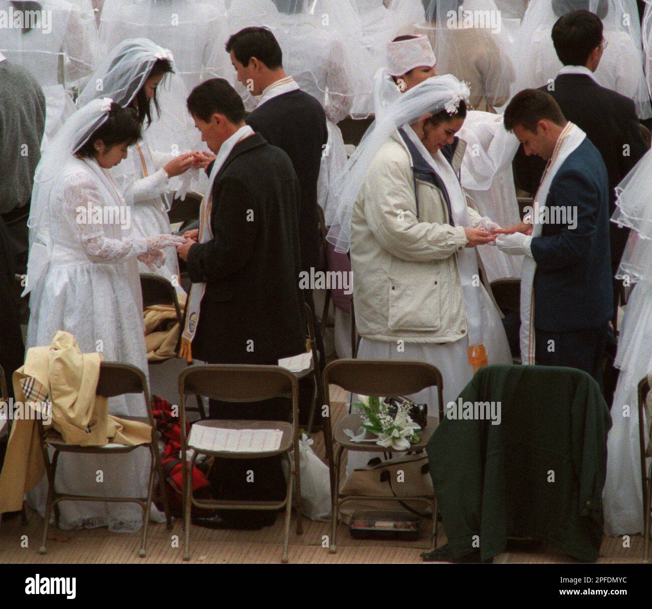 Couples exchange rings during the mass wedding ceremony officiated by ...